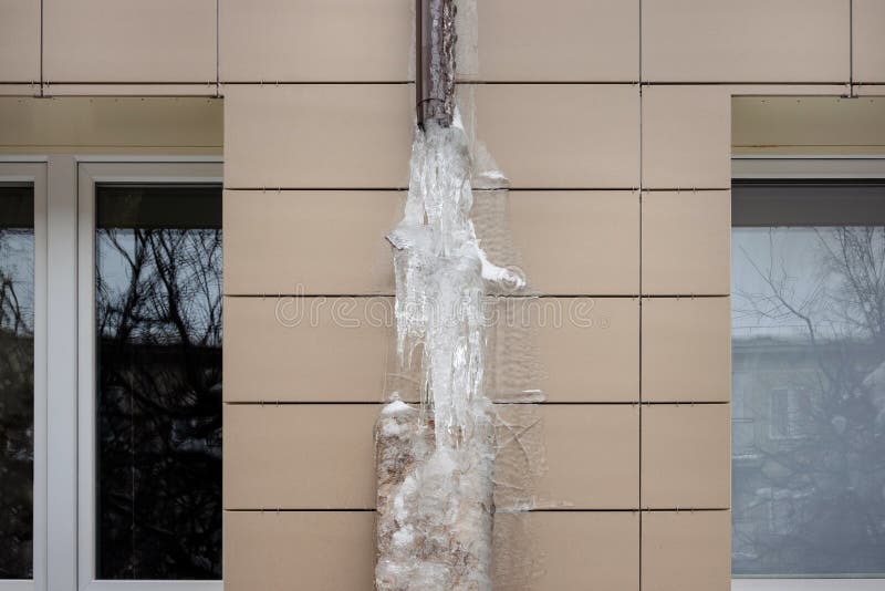 Frozen Rain Pipe on an Apartment Building. Ice on the Building Wall ...