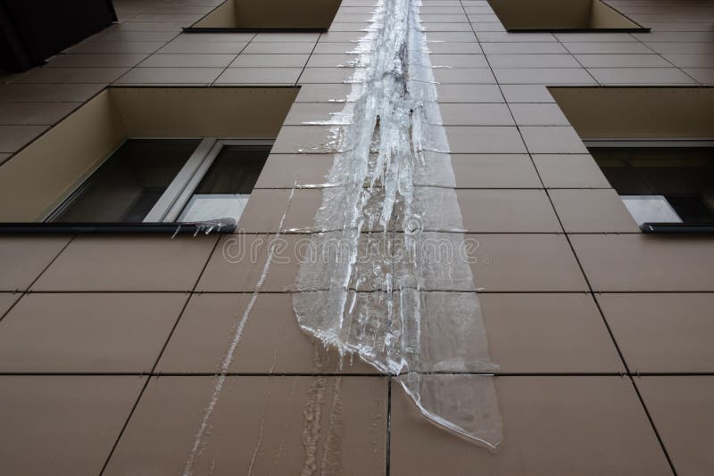 Frozen Rain Pipe on an Apartment Building. Ice on the Building Wall ...
