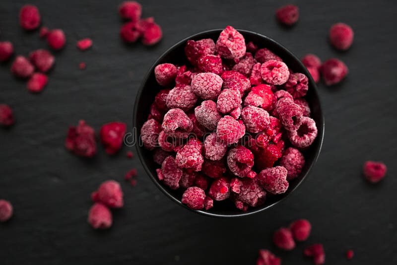 Frozen Raspberries in Bowl, Covered with Ice on Dark Background, Top ...