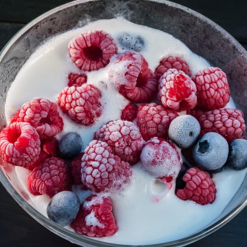 Frozen Raspberry and Blueberry with Ice Cream in a Glass Bowl Stock ...