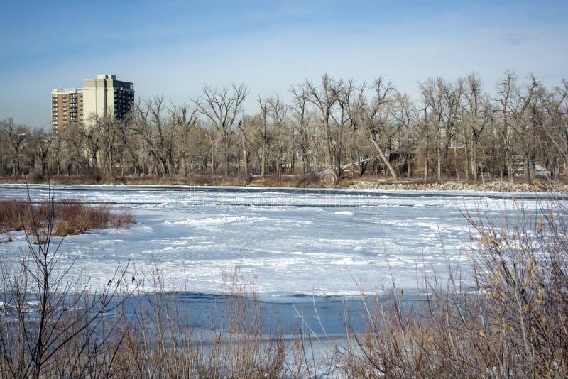 Frozen River Iced Over with Trees Lining Edges Stock Image - Image of ...