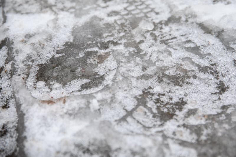 Frozen Water on the Sidewalk, Footprints in the Ice. Weather Conditions ...