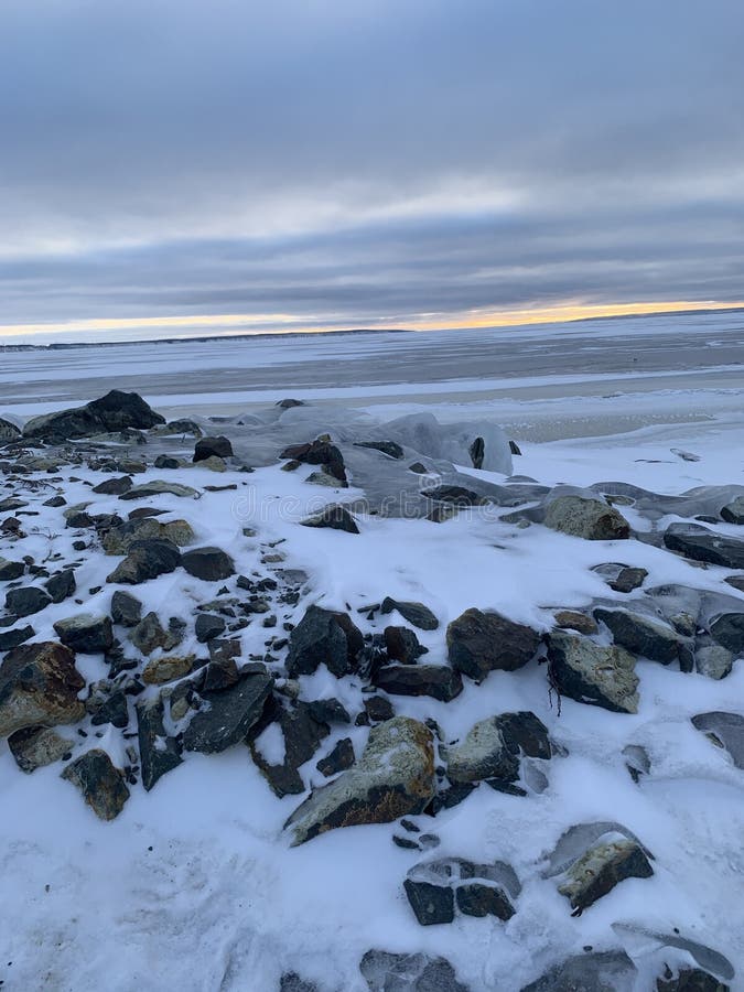 Frozen wave on pebbles stock photo. Image of nature - 206982794