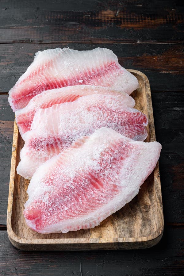 Frozen White Fish Fillet, on Old Wooden Table Stock Photo - Image of ...
