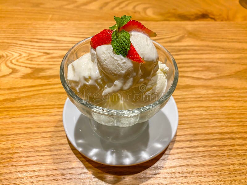 Frozen Yogurt Garnish with Strawberry Slices and Mint Leaf Stock Photo ...