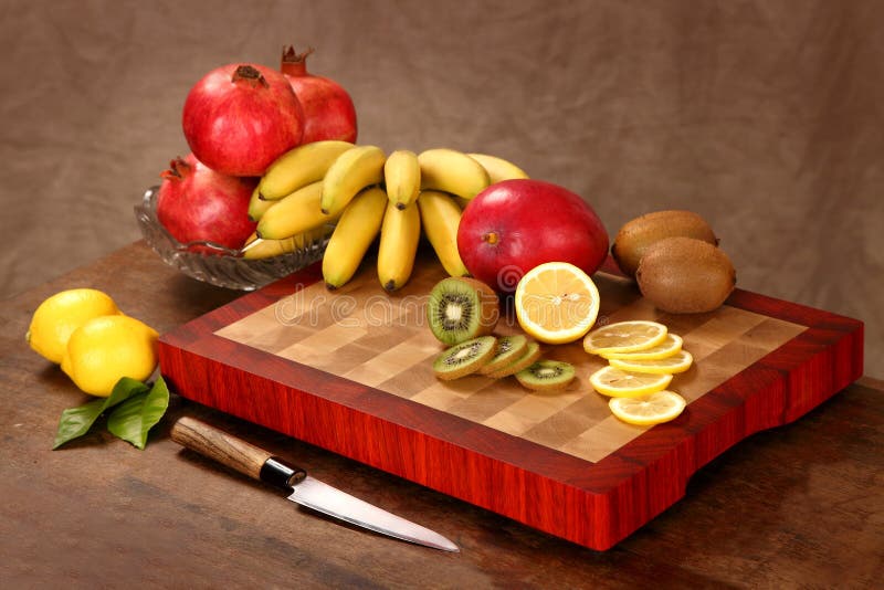 Fruit on a chopping board stock photo. Image of kiwi - 55720280