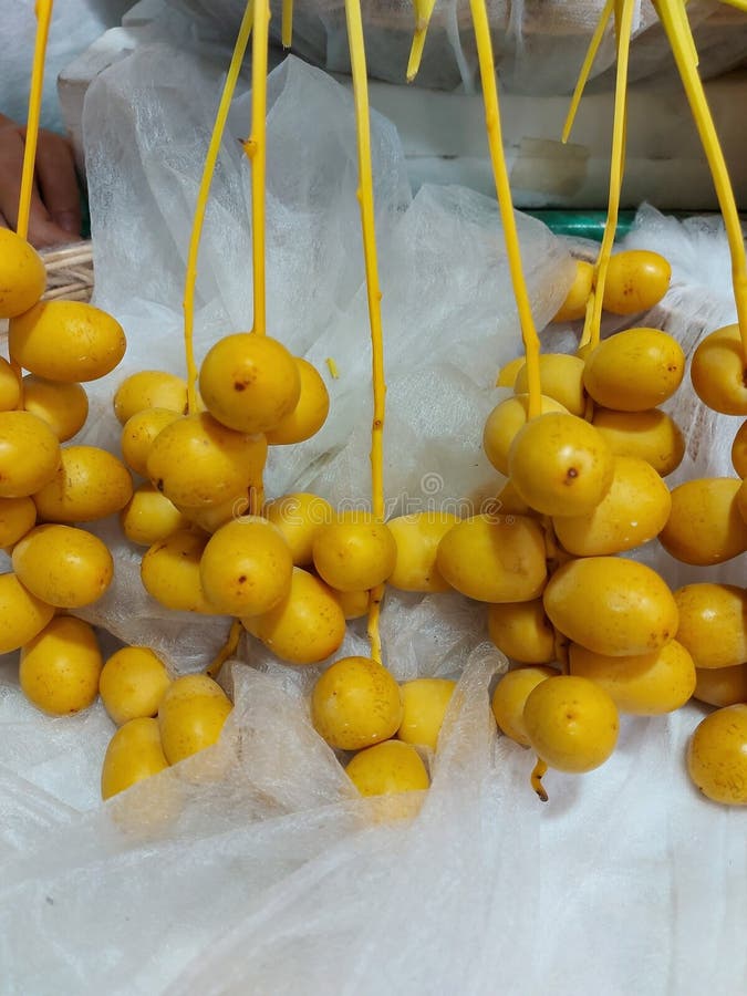 Yellow Date Smoothie in a Glass Decorated with Dates on an Isolated ...