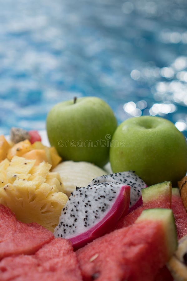 Fruit by the Pool with Beach in the Background. Stock Photo - Image of ...