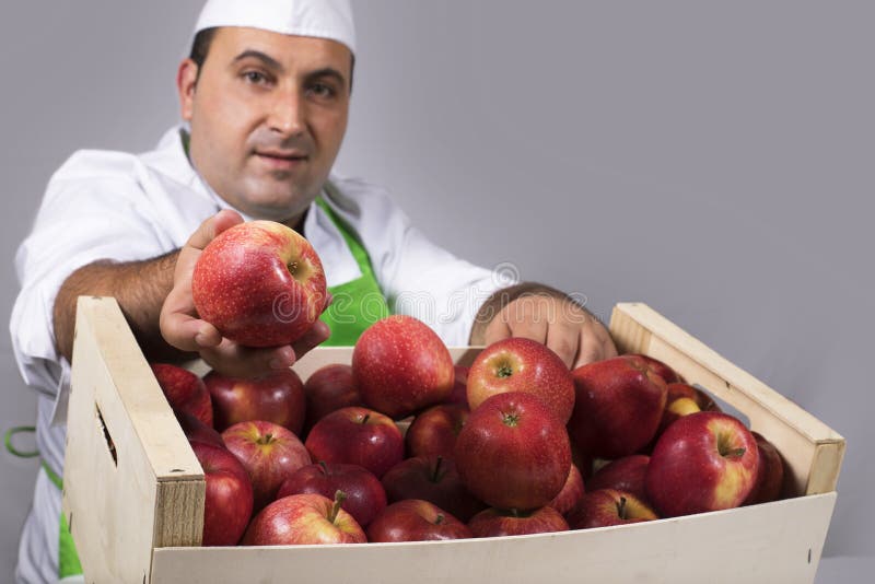 Fruit Seller with Box of Apples Stock Photo - Image of employee, give ...