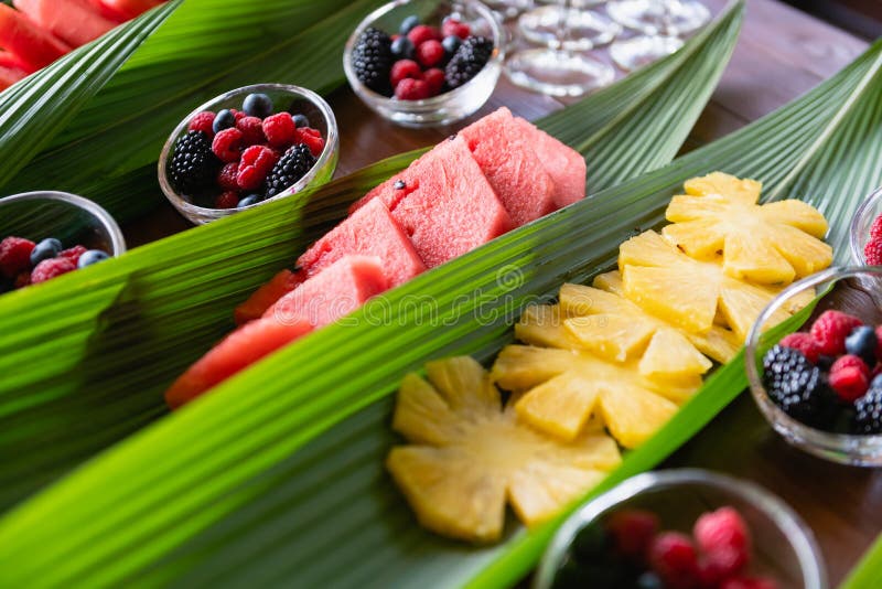 Fruit Slices Inside Green Leaves on Buffet Stock Photo - Image of ...