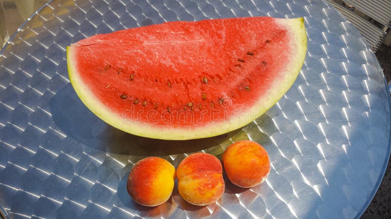 Fruit on the Table. Bright Red Watermelon with Three Peaches Stock ...