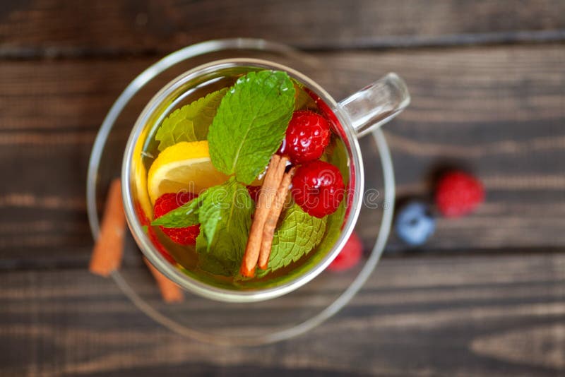 Fruit Tea in a Transparent Cup with Raspberries Lemon Mint and Cinnamon ...