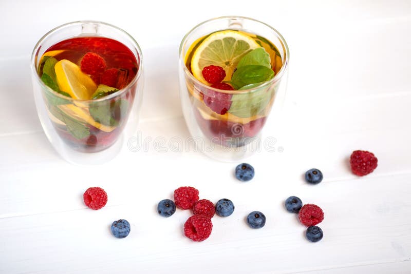 Fruit Tea in a Transparent Cup with Raspberries Lemon Mint and Cinnamon ...