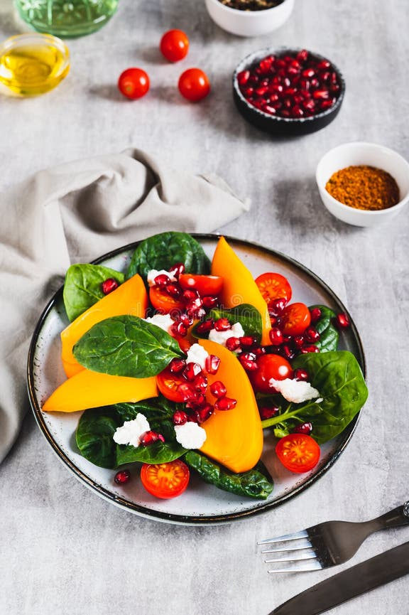 Fruit and Vegetable Salad with Persimmon on a Plate on the Table ...