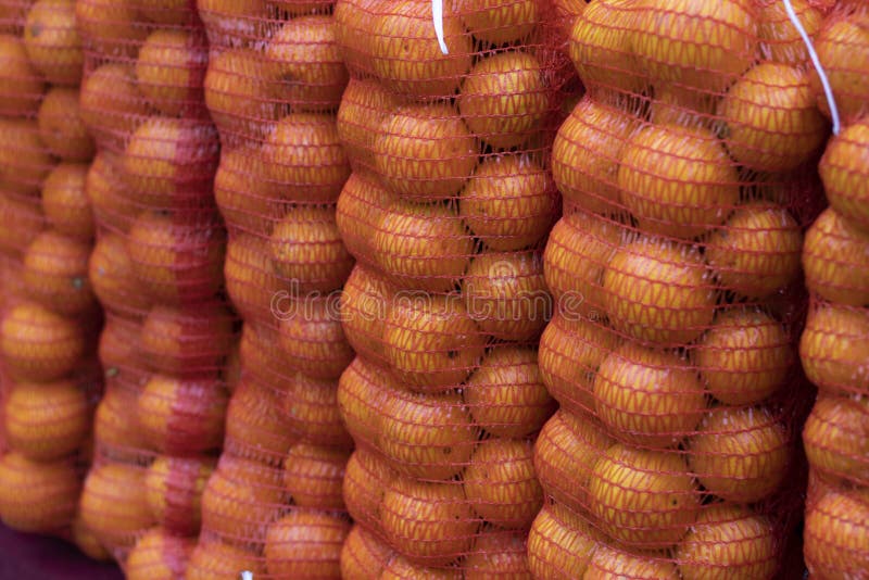 Fruit Vendor Displays Bags of Oranges for Sale Stock Image - Image of ...