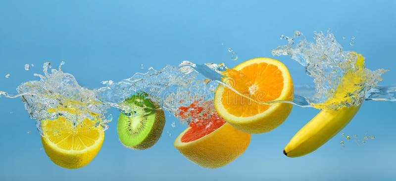Fruits Mix Splashing into Clear Water on Blue Background Stock Image ...
