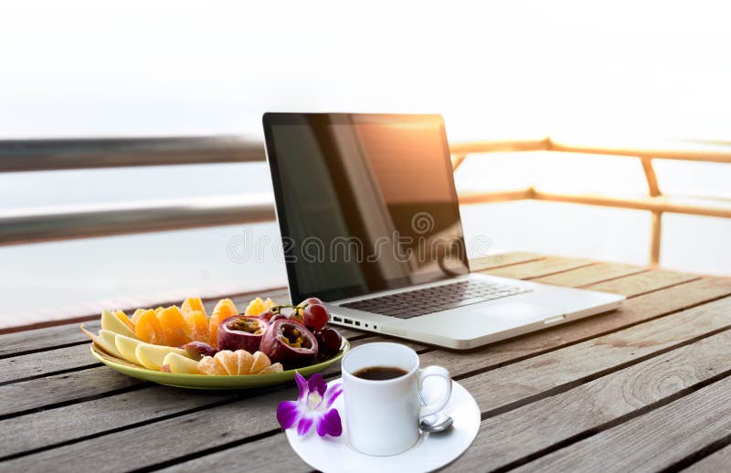 Fruits Salad and Cup of Coffee and Flower with Computer Laptop Stock ...