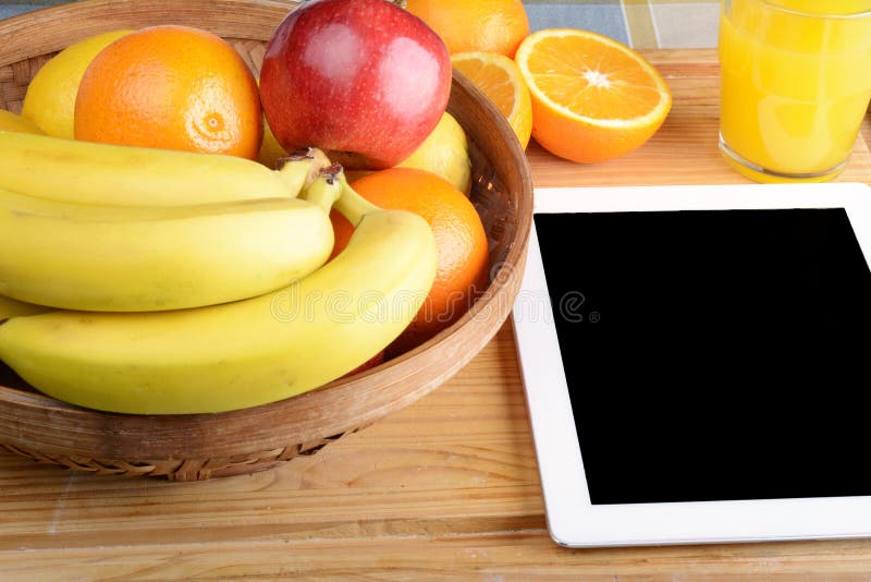 Fruits and a Tablet PC on Wooden Table. Stock Image - Image of ...