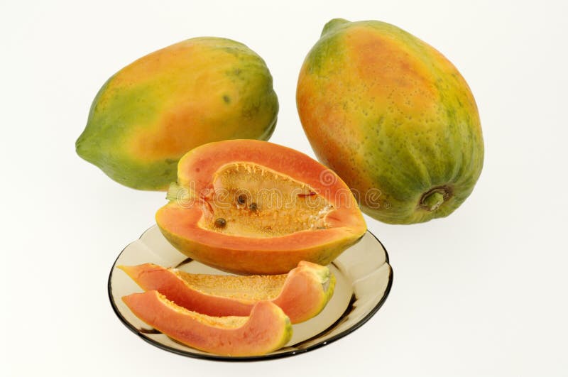 Two Full Papaya with Three Small Pieces Kept in Plate on White ...