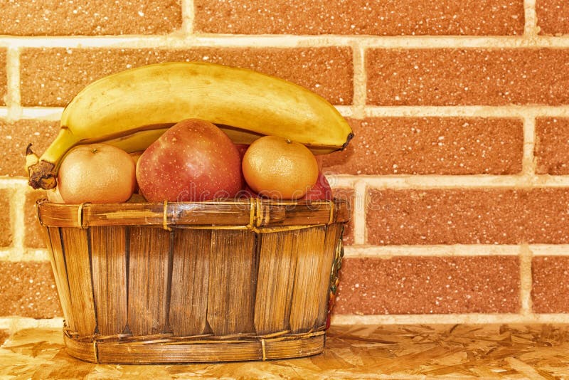 Fruits in a Wicker Basket on a Brick Wall Background Stock Image ...