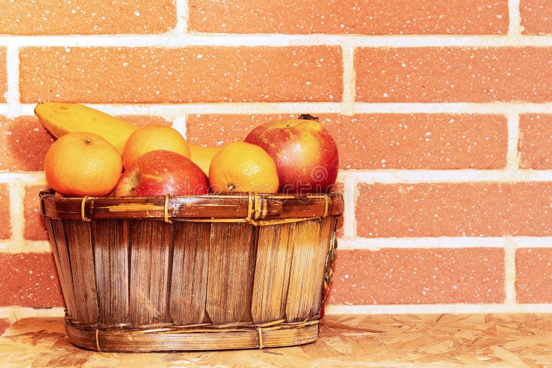 Fruits in a Wicker Basket on a Brick Wall Background Stock Image ...