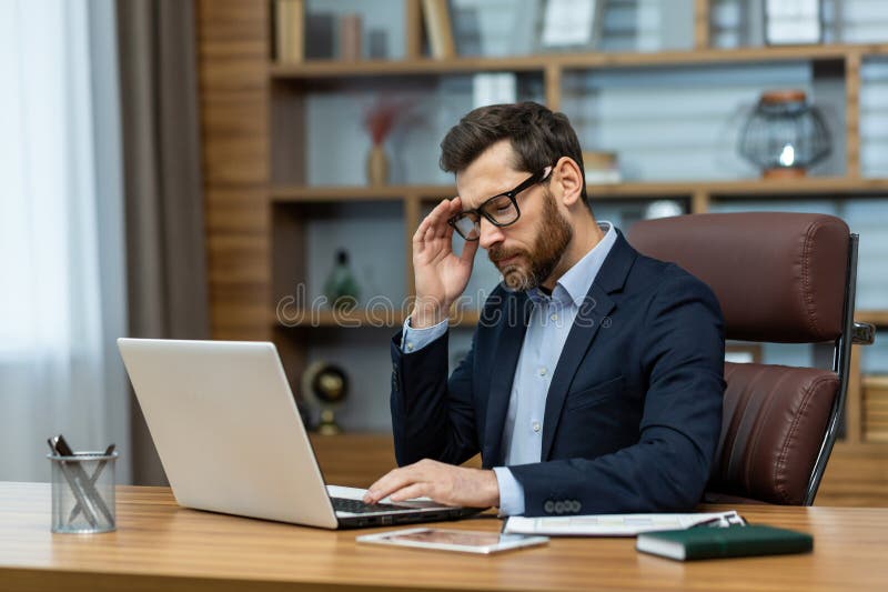Frustrated Administrator Experiencing Headache while Sitting by Desk ...
