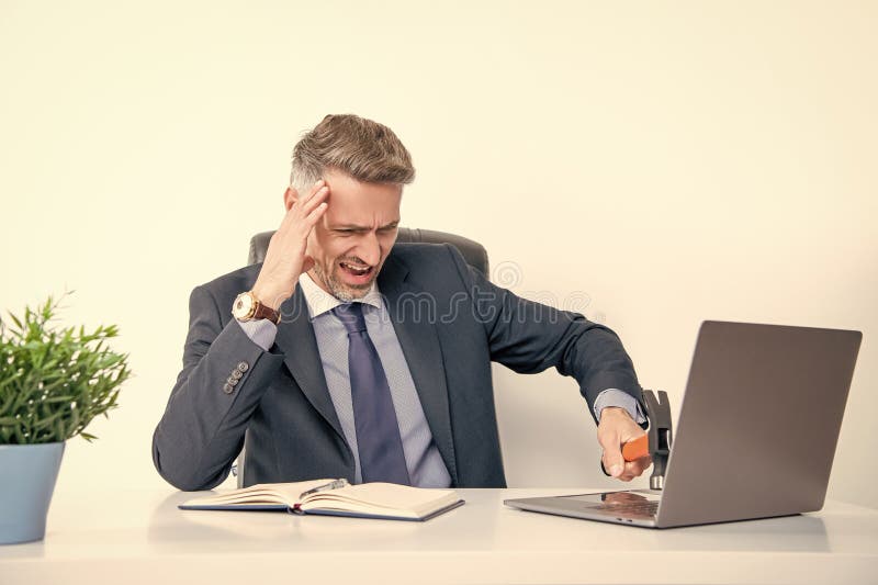 Frustrated Boss Hitting Laptop with Hammer in Office Stock Photo ...