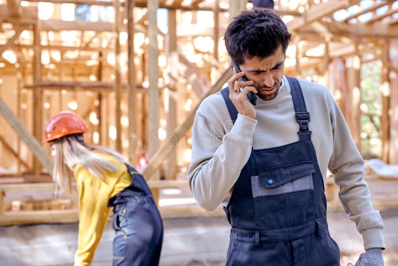 Frustrated Builder Architect Man Talking on Phone Against New ...