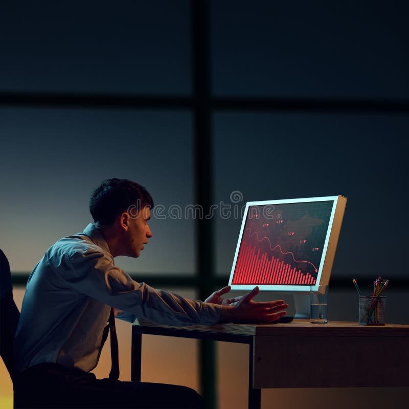 Frustrated Businessman in Office at Night Gestures Angrily at Computer ...