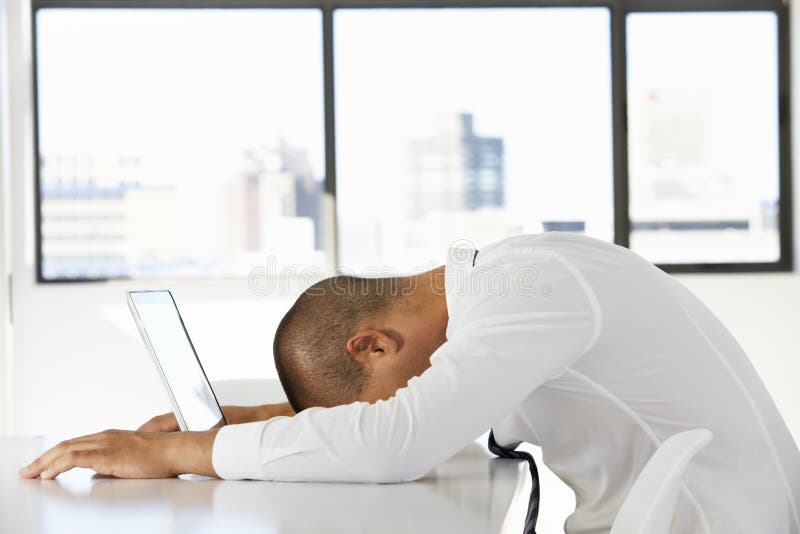 Frustrated Businessman Sitting at Desk in Office Using Laptop Stock ...