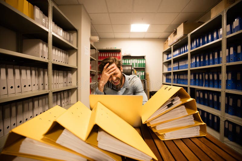 Frustrated Businessman Using Laptop in Storage Room Stock Image - Image ...