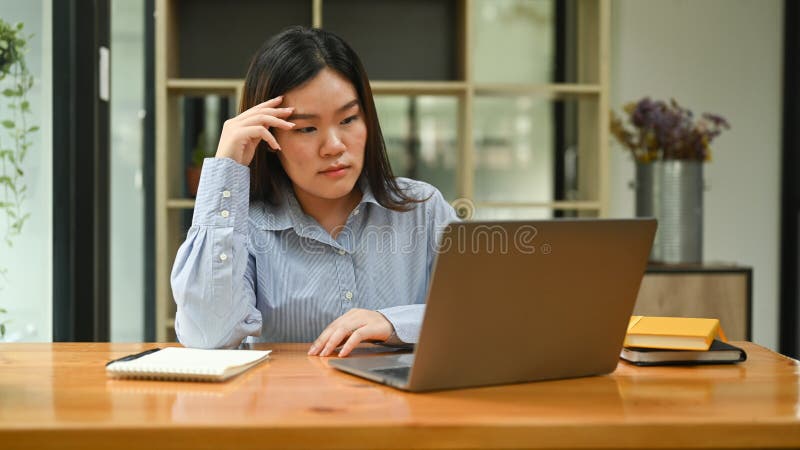 Frustrated Female Worker Holding Her Head and Looking at Laptop Screen ...
