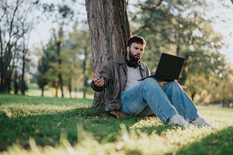 Frustrated Man with Laptop Sitting Under Tree in the Park Stock Image ...