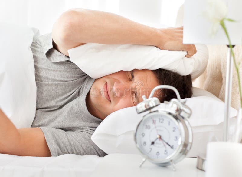 Frustrated Man Listening To His Alarm Clock Stock Photo - Image of ...