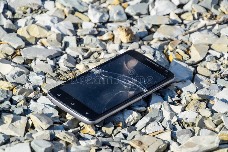 Frustrated Phone on the Rocks. Glass Shattered on Smartphone Stock ...