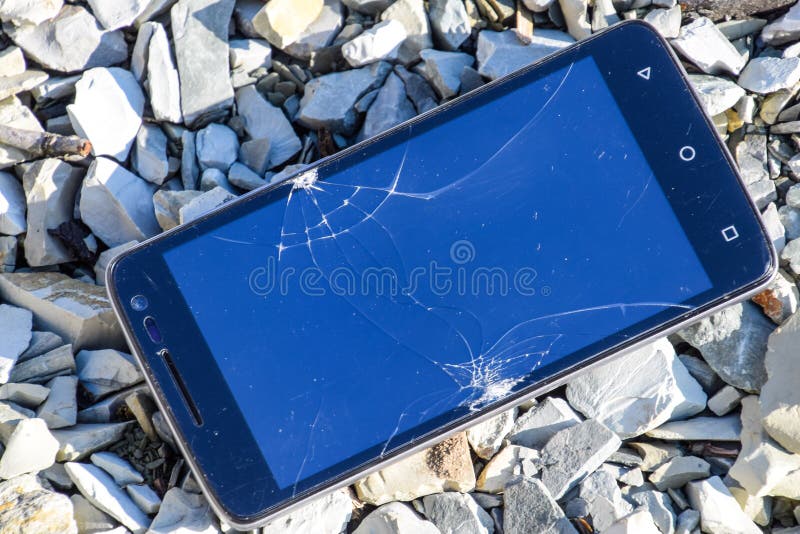 Frustrated Phone on the Rocks. Glass Shattered on Smartphone Stock ...