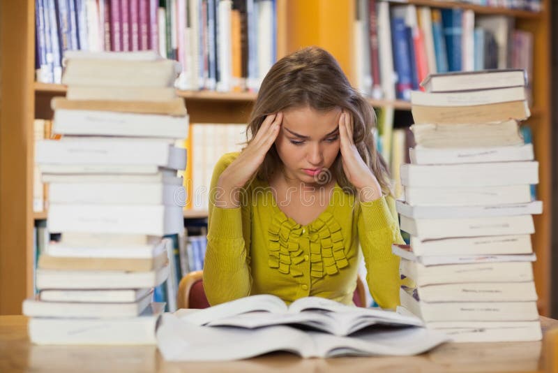 Frustrated Pretty Student Studying between Piles of Books Stock Image ...