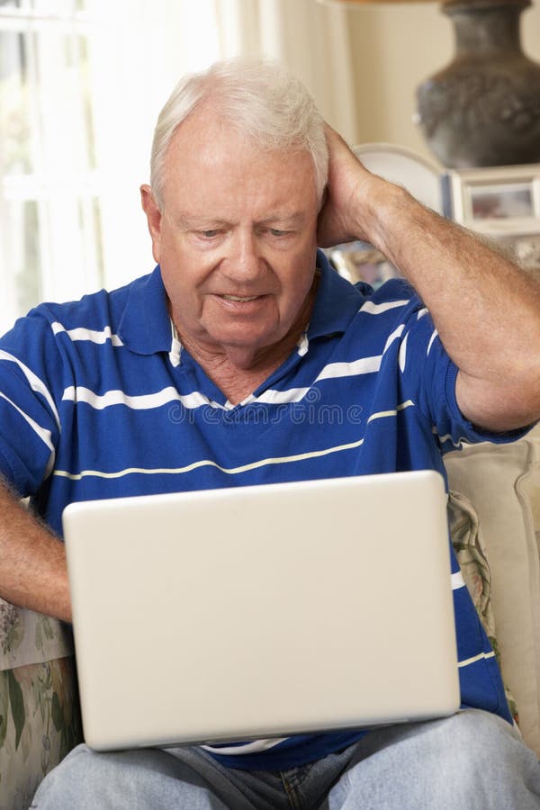 Frustrated Retired Senior Man Sitting on Sofa at Home Using Laptop ...