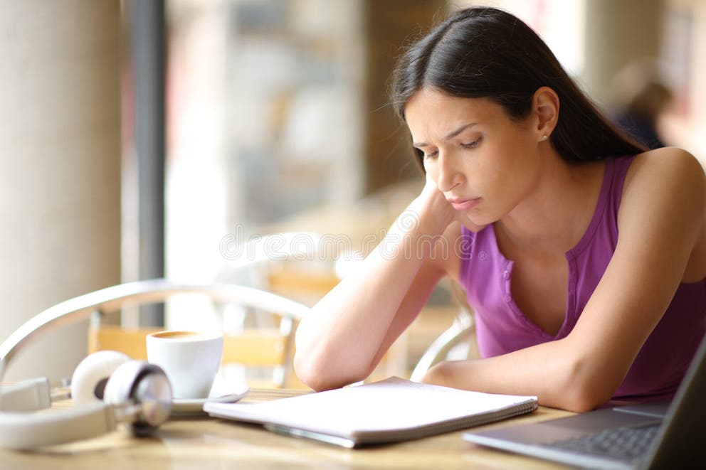 Frustrated Student in a Bar Reading Notes Stock Photo - Image of laptop ...