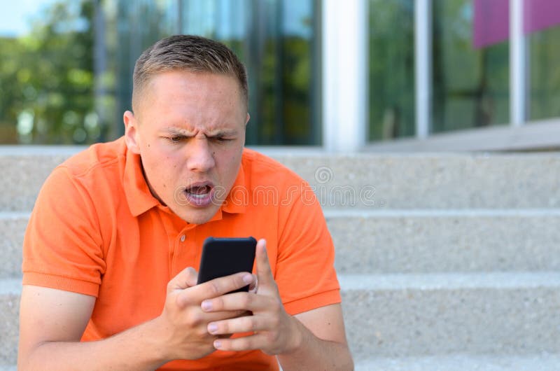 Frustrated Young Man Gesturing at His Mobile Phone Stock Photo - Image ...