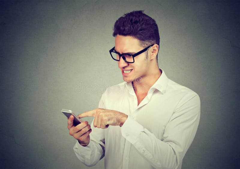 Frustrated Young Man Sending Text Message Using Mobile Phone Stock ...