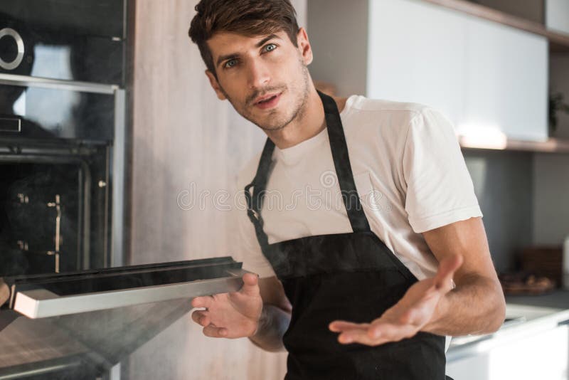 Frustrated Young Man Standing Near Broken Oven Stock Photo - Image of ...