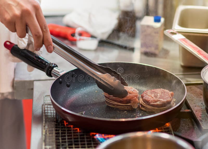 Fry the Meat in a Frying Pan. Chef Preparing and Spicing Meat ...