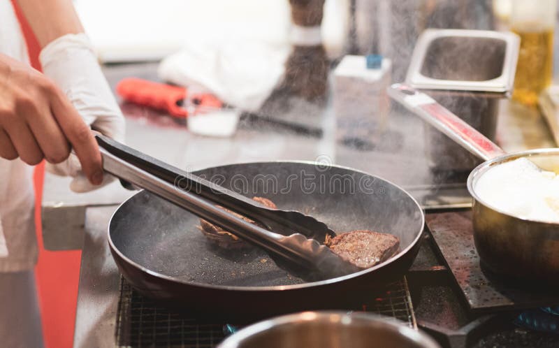 Fry the Meat in a Frying Pan. Chef Preparing and Spicing Meat ...