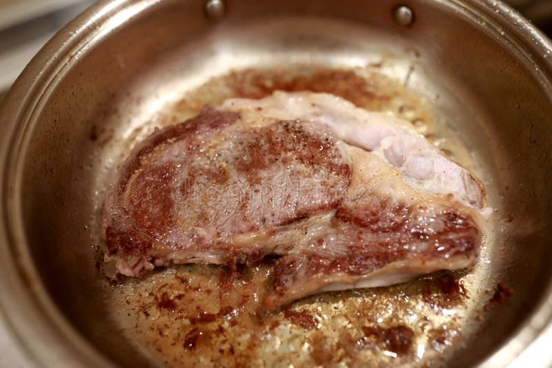 Frying beef steak in pan stock image. Image of beef - 216178159