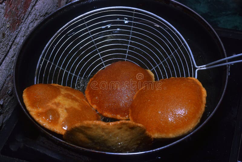Frying Chapati(poori) with Spoon on Frying Pan, Boiling Oil in Frying ...