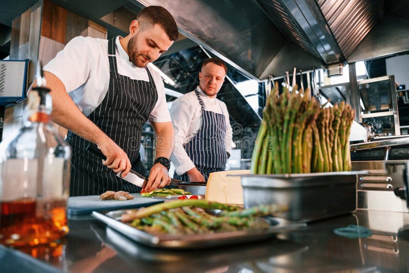 Frying the Meat. Kitchen Workers is Together Preparing the Food Stock ...
