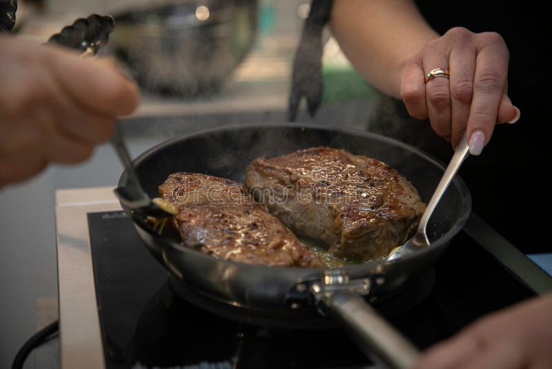 Frying meat on frying pans stock image. Image of potatoes - 183291033