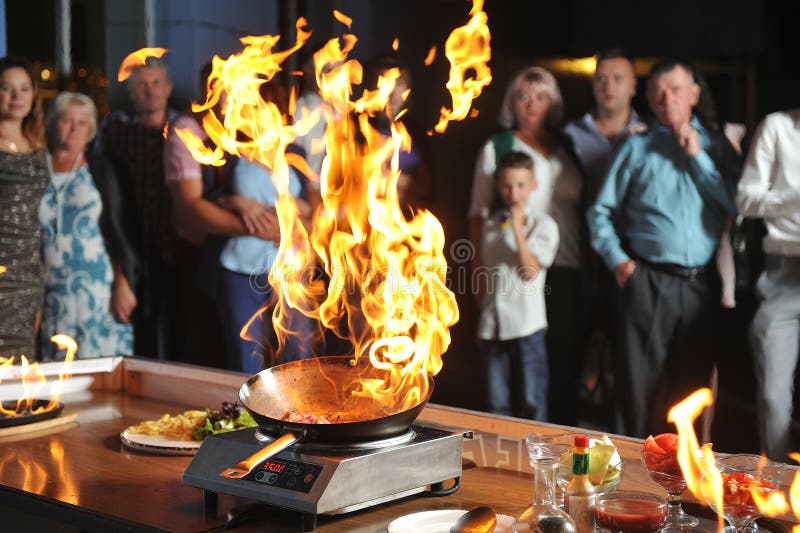 Frying Pan with Fire at a Cooking Show for People in a Restaurant Stock ...