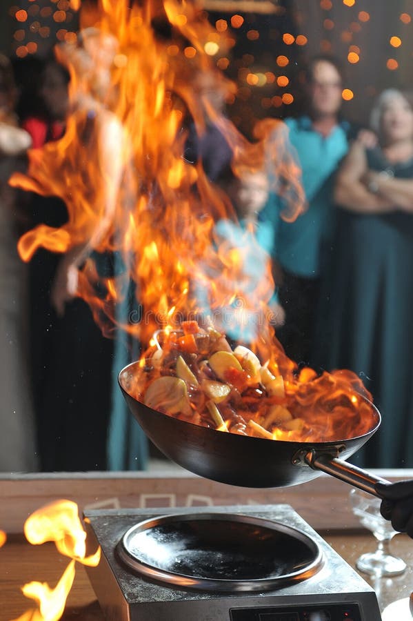 A Frying Pan with Fire at a Cooking Show in a Restaurant for People ...